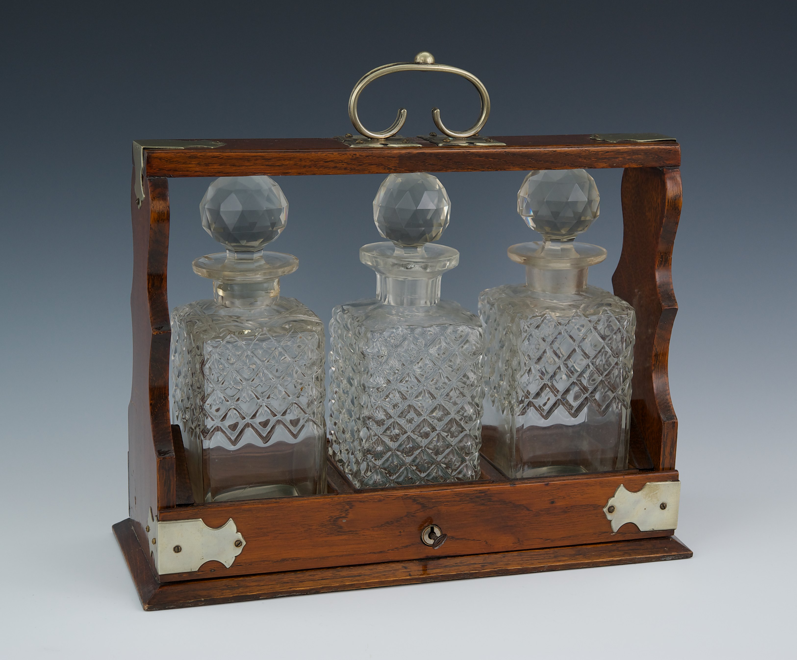 A British Oak and Gilt Metal Tantalus Set, 09.25.10, Sold: $178.25